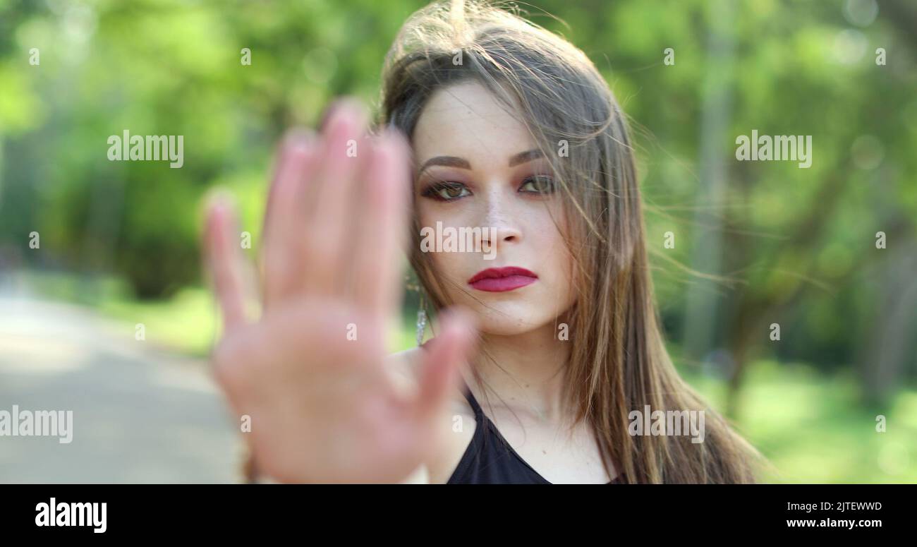 Millennial girl signalling to STOP with hand, woman waving finger ...