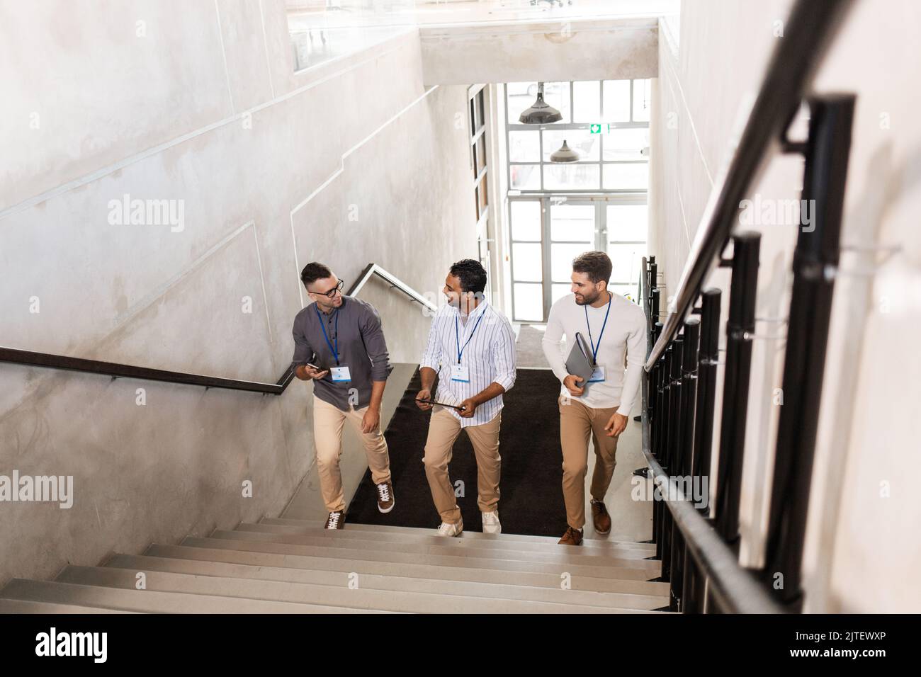 Businessman walking up staircase smartphone hi-res stock photography ...