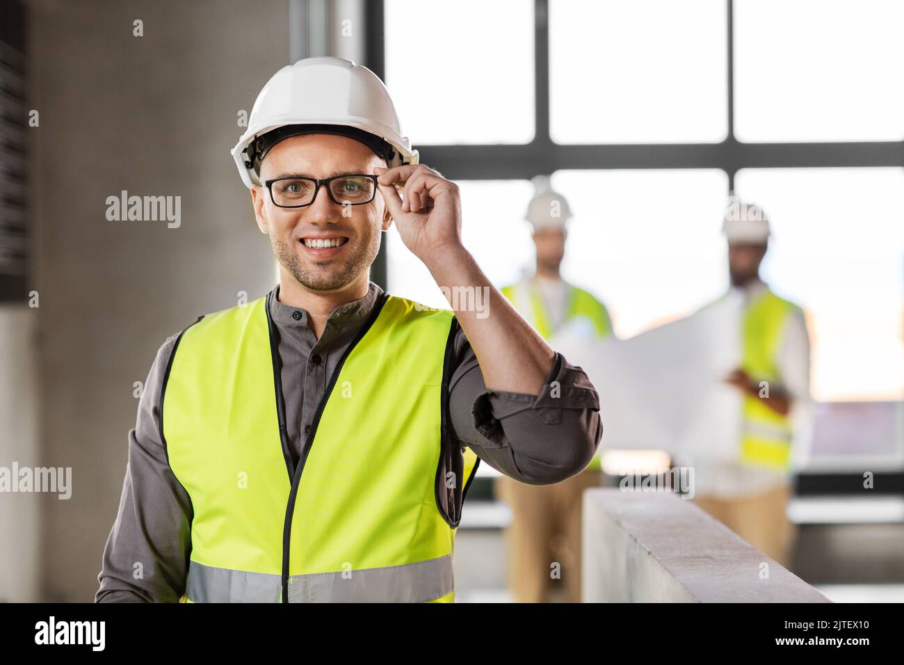 male architect in helmet and safety west at office Stock Photo - Alamy