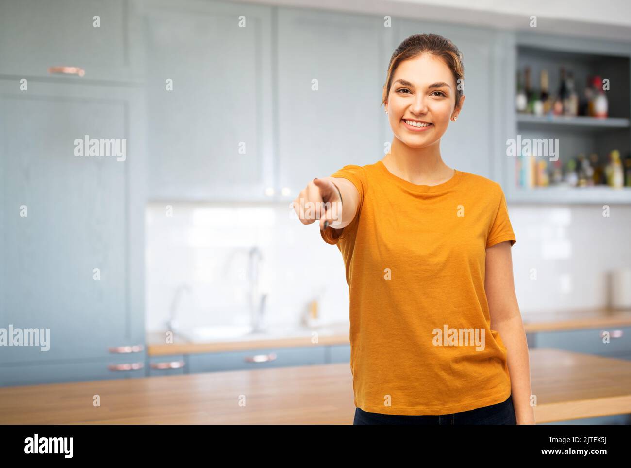 happy woman pointing finger to camera at kitchen Stock Photo - Alamy