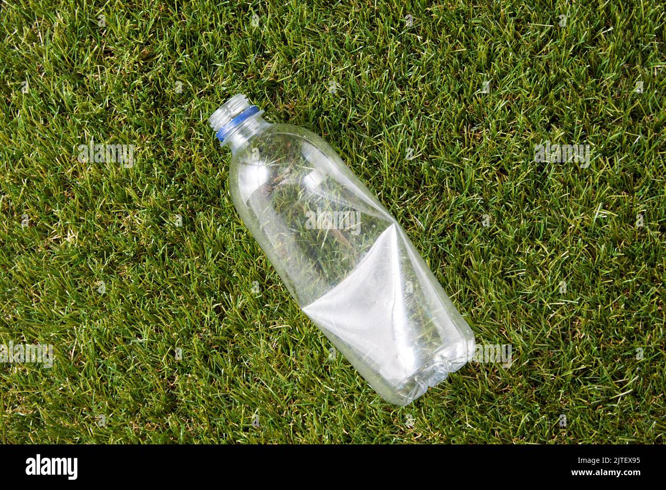 close up of empty used plastic bottle on grass Stock Photo - Alamy