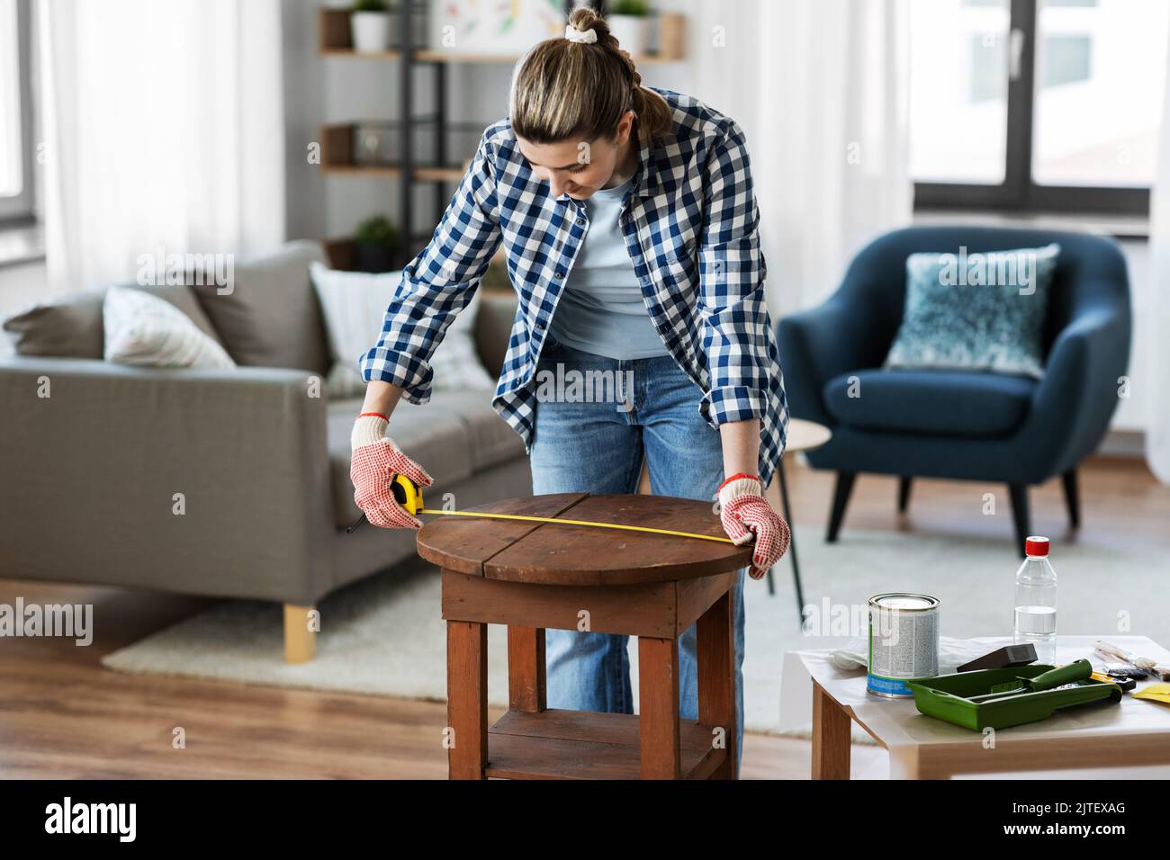 woman with ruler measuring table for renovation Stock Photo - Alamy
