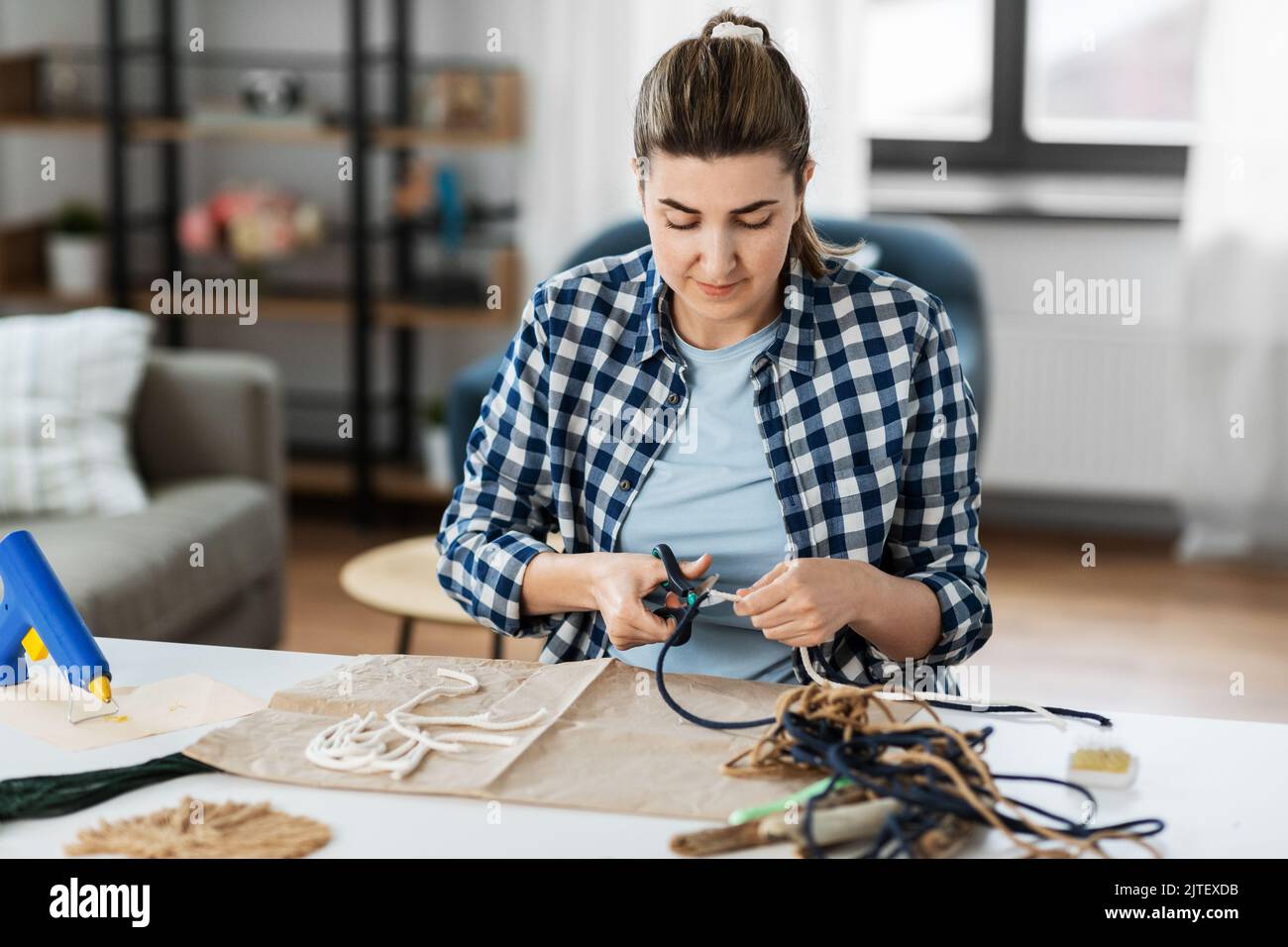 woman cutting macrame cords with scissors Stock Photo - Alamy