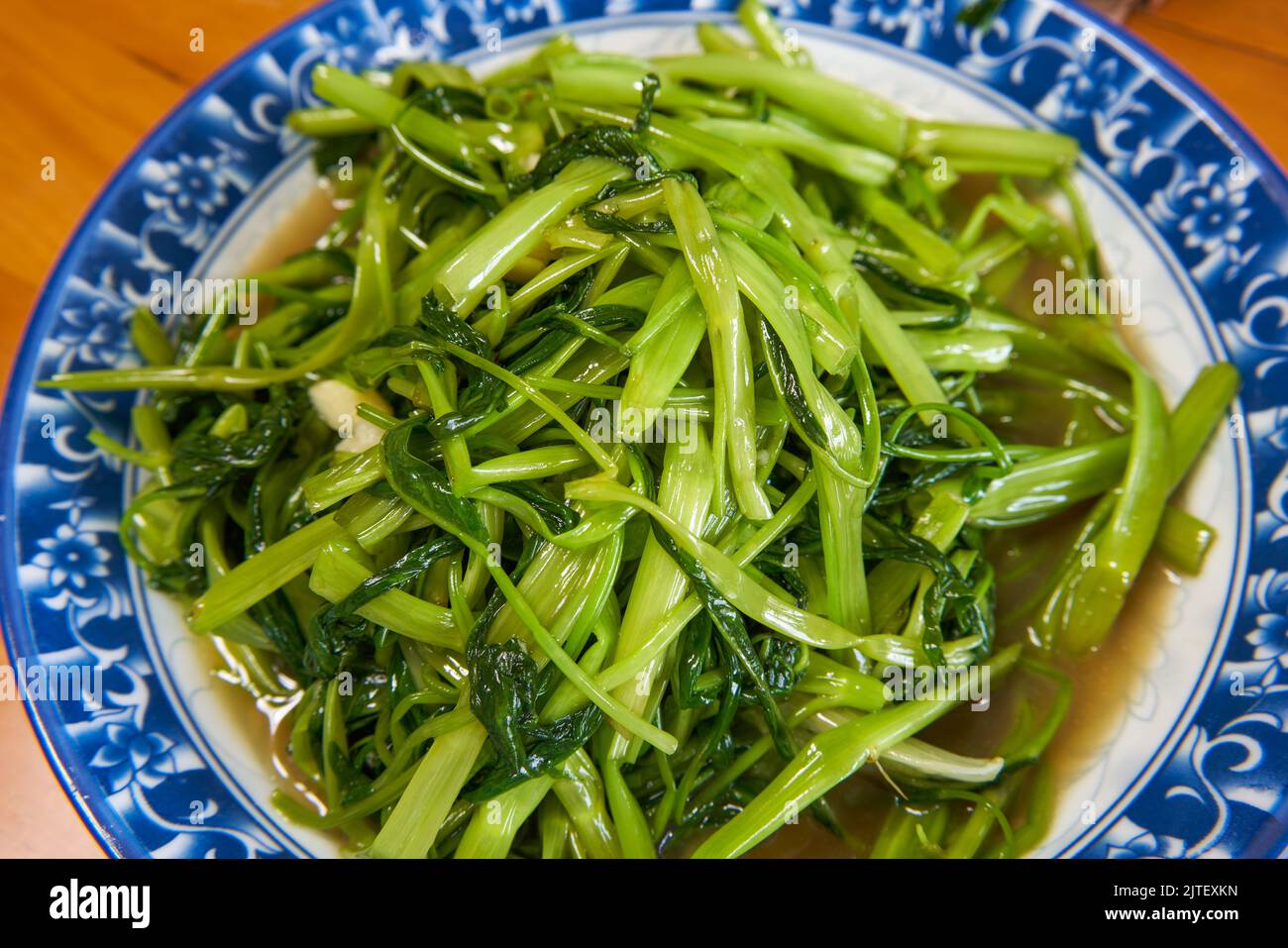 A delicious Chinese home-style dish, fried water spinach Stock Photo ...