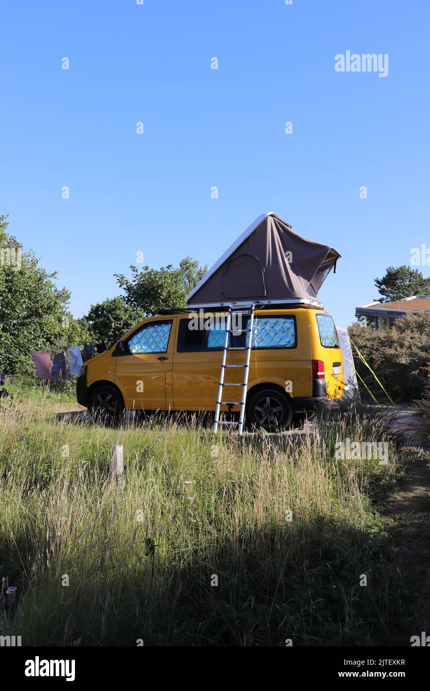 a new yellow camper van with a roof tent Stock Photo - Alamy