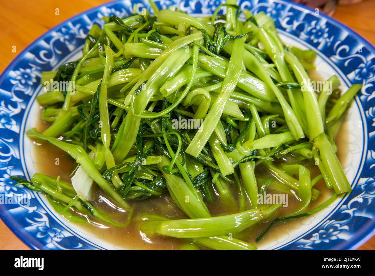 A delicious Chinese home-style dish, fried water spinach Stock Photo ...