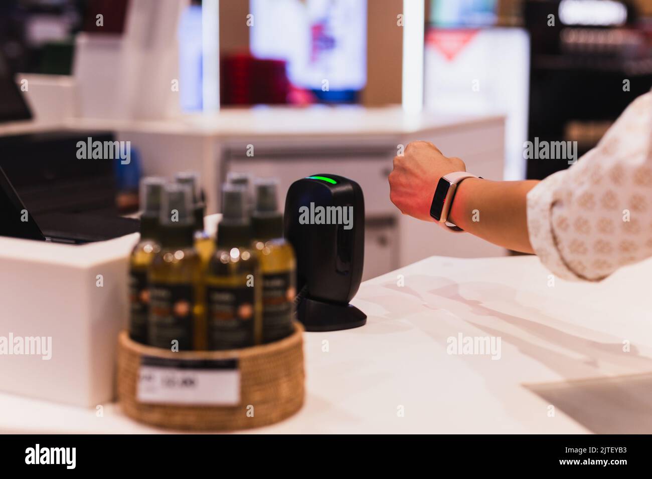 Customer making wireless payment using smartwatch at shopping store ...