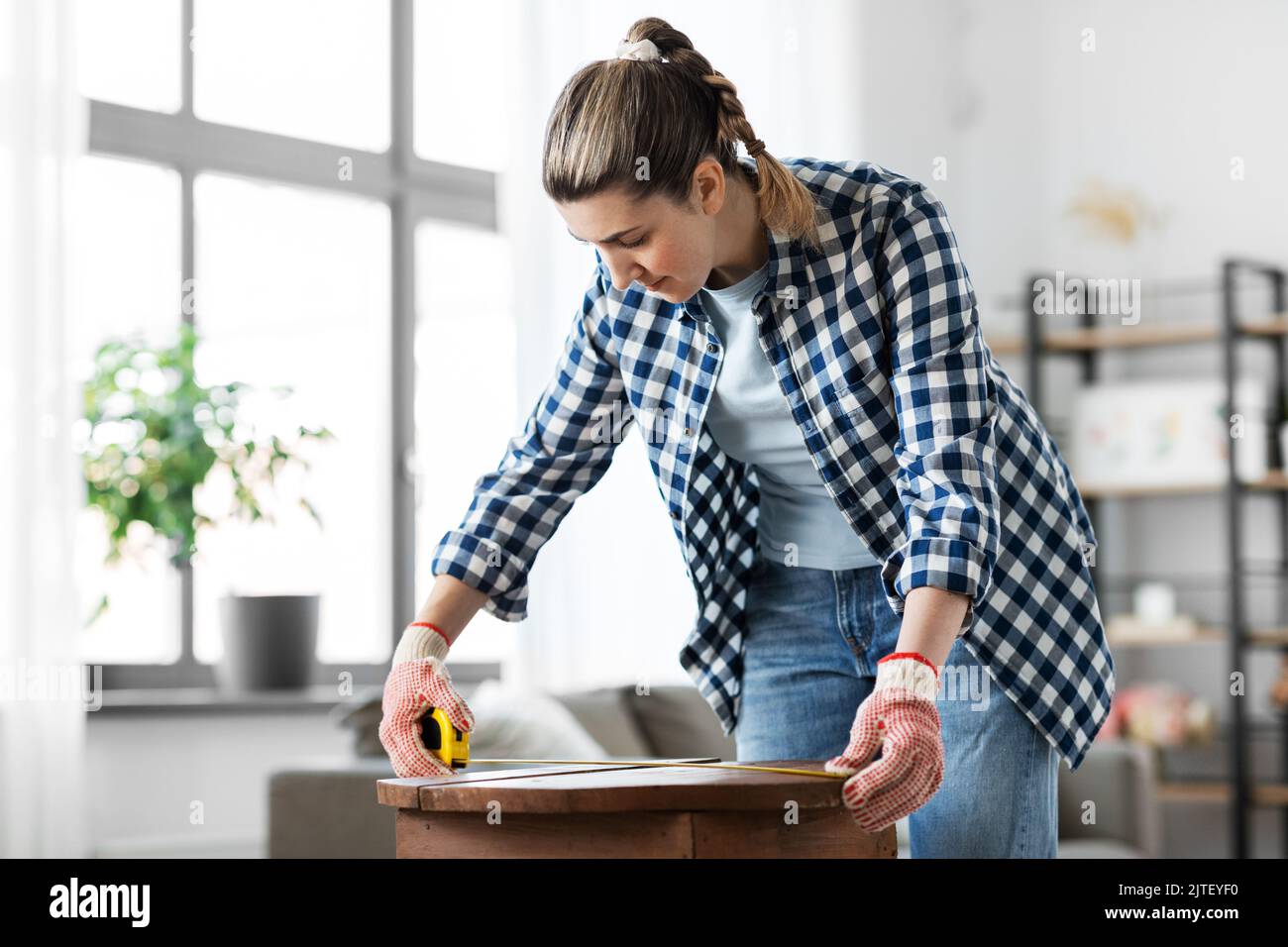 woman with ruler measuring table for renovation Stock Photo - Alamy
