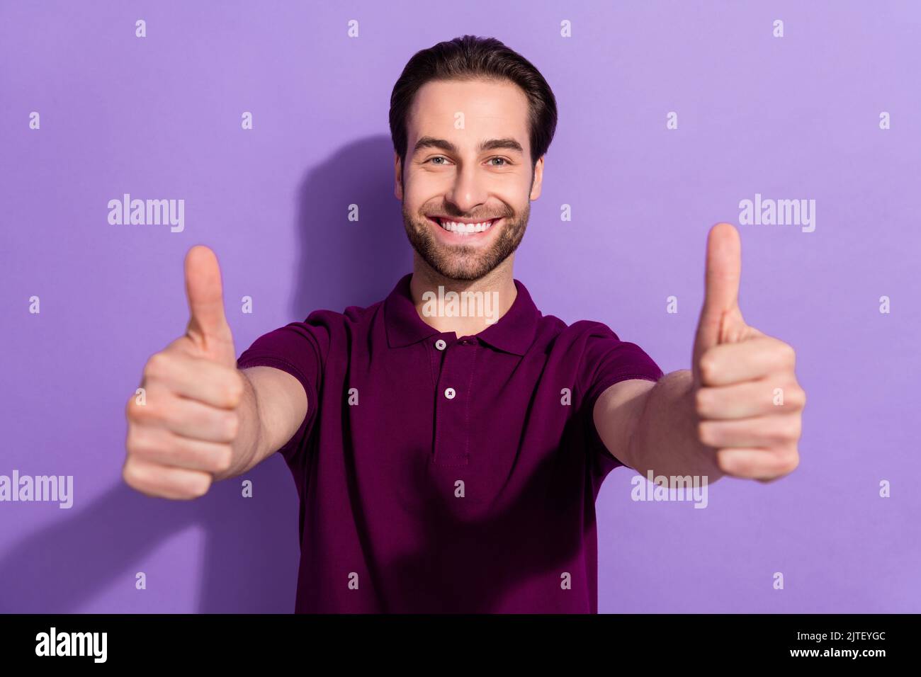Portrait of attractive young man showing thumb-up cheer you up good job ...