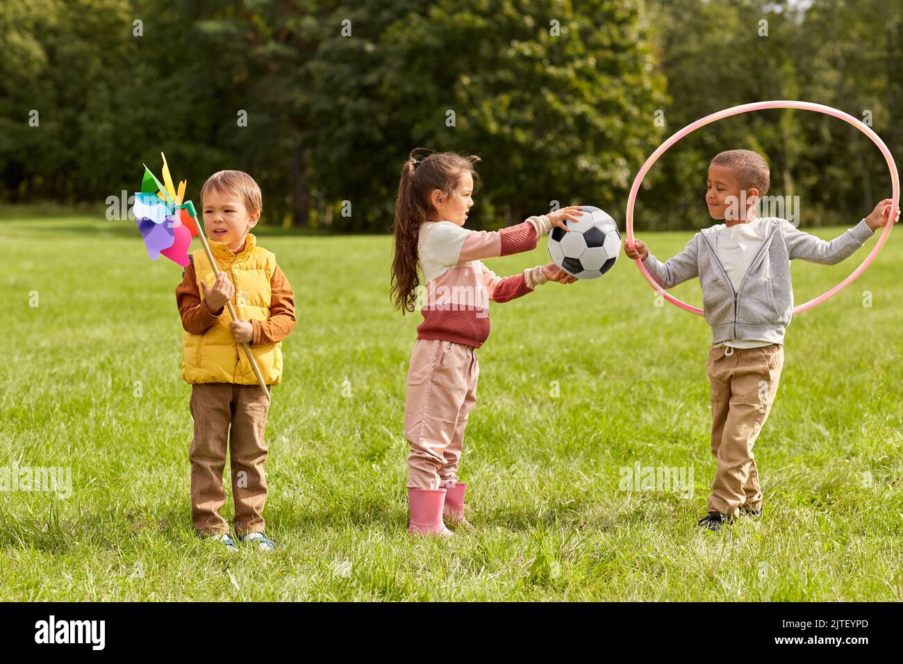 happy kids with pinwheel having fun at park Stock Photo - Alamy