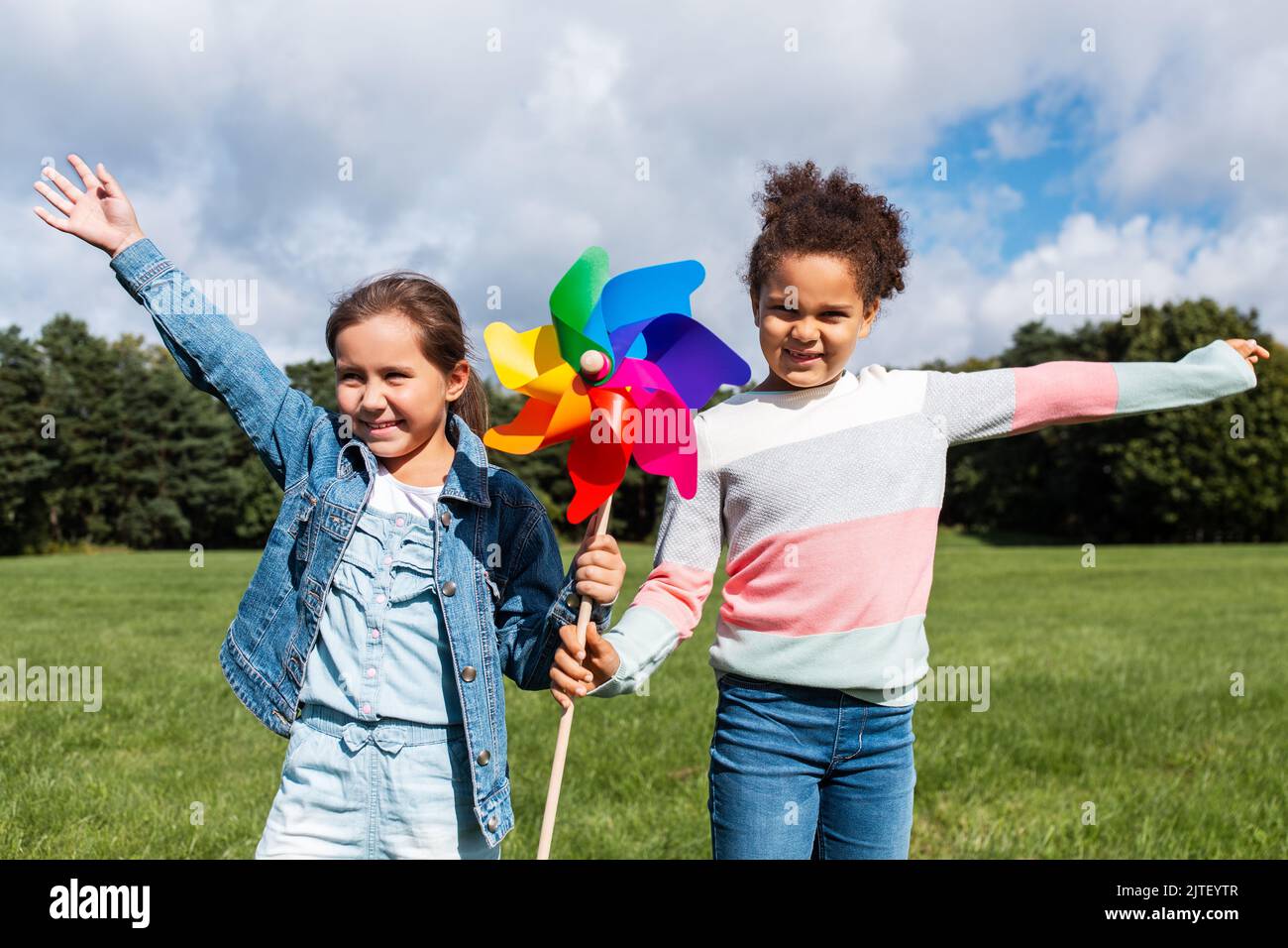 happy girls with pinwheel having fun at park Stock Photo - Alamy