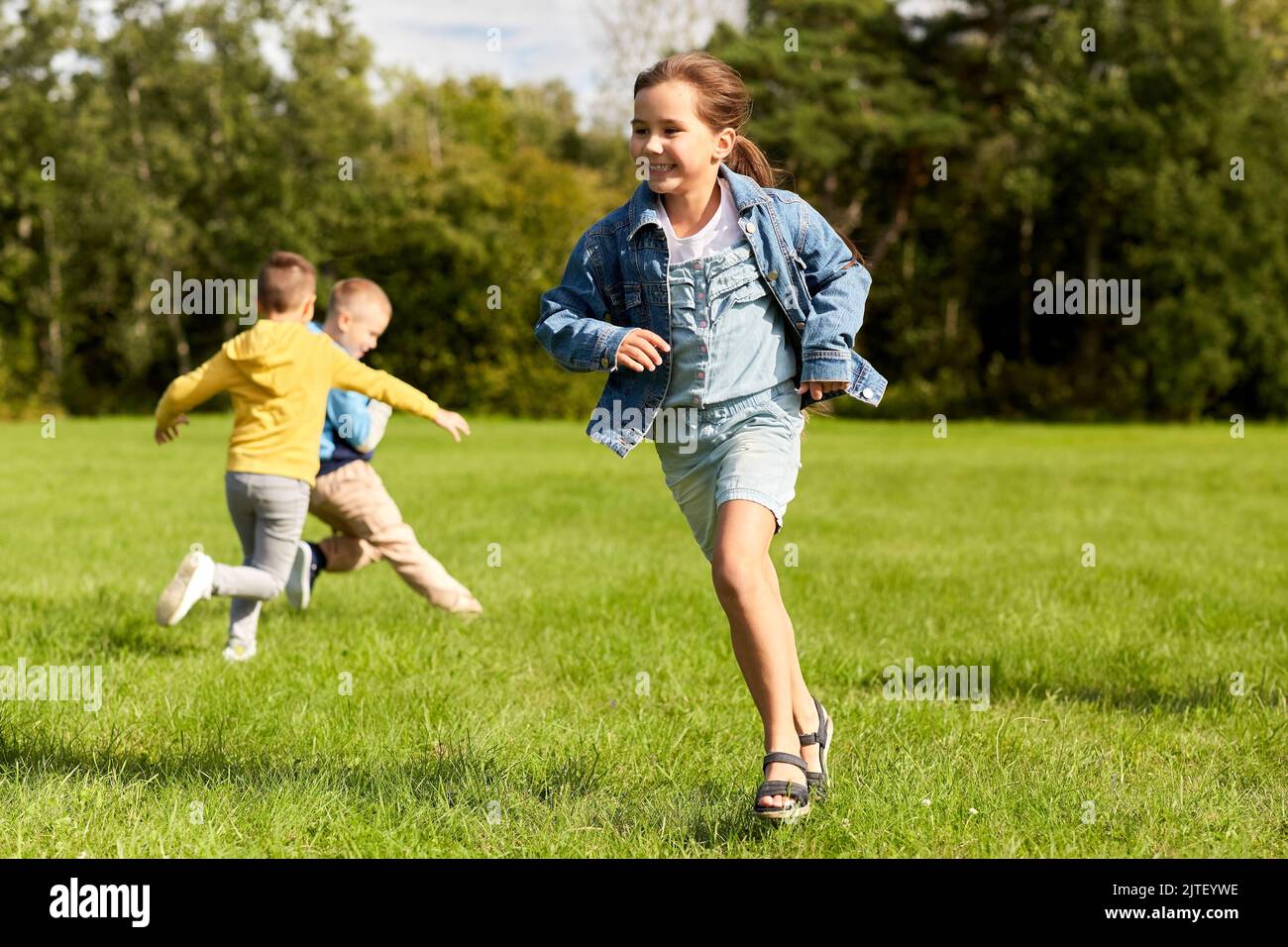 happy children playing and running at park Stock Photo - Alamy