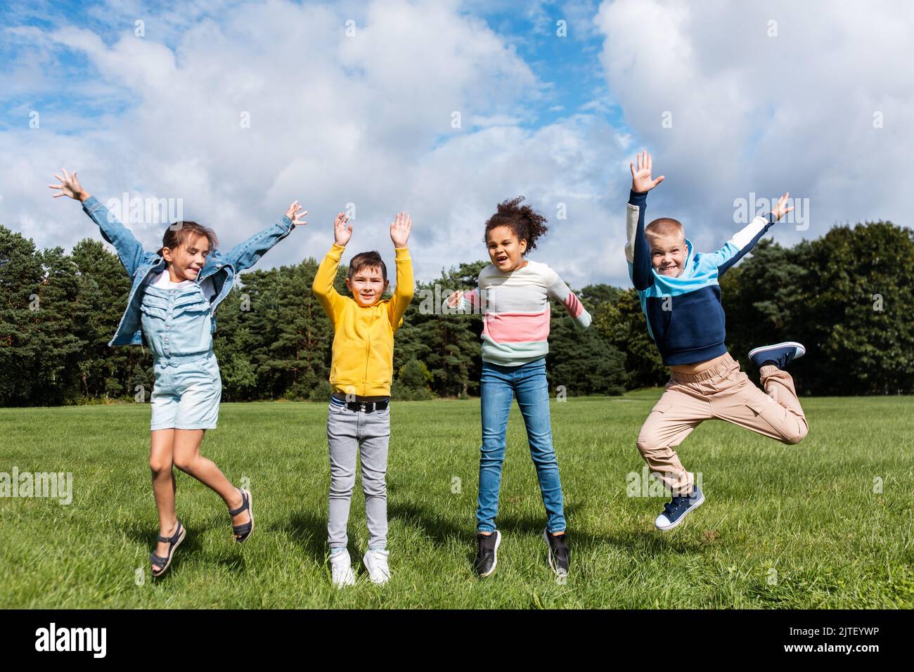happy children jumping and having fun at park Stock Photo - Alamy