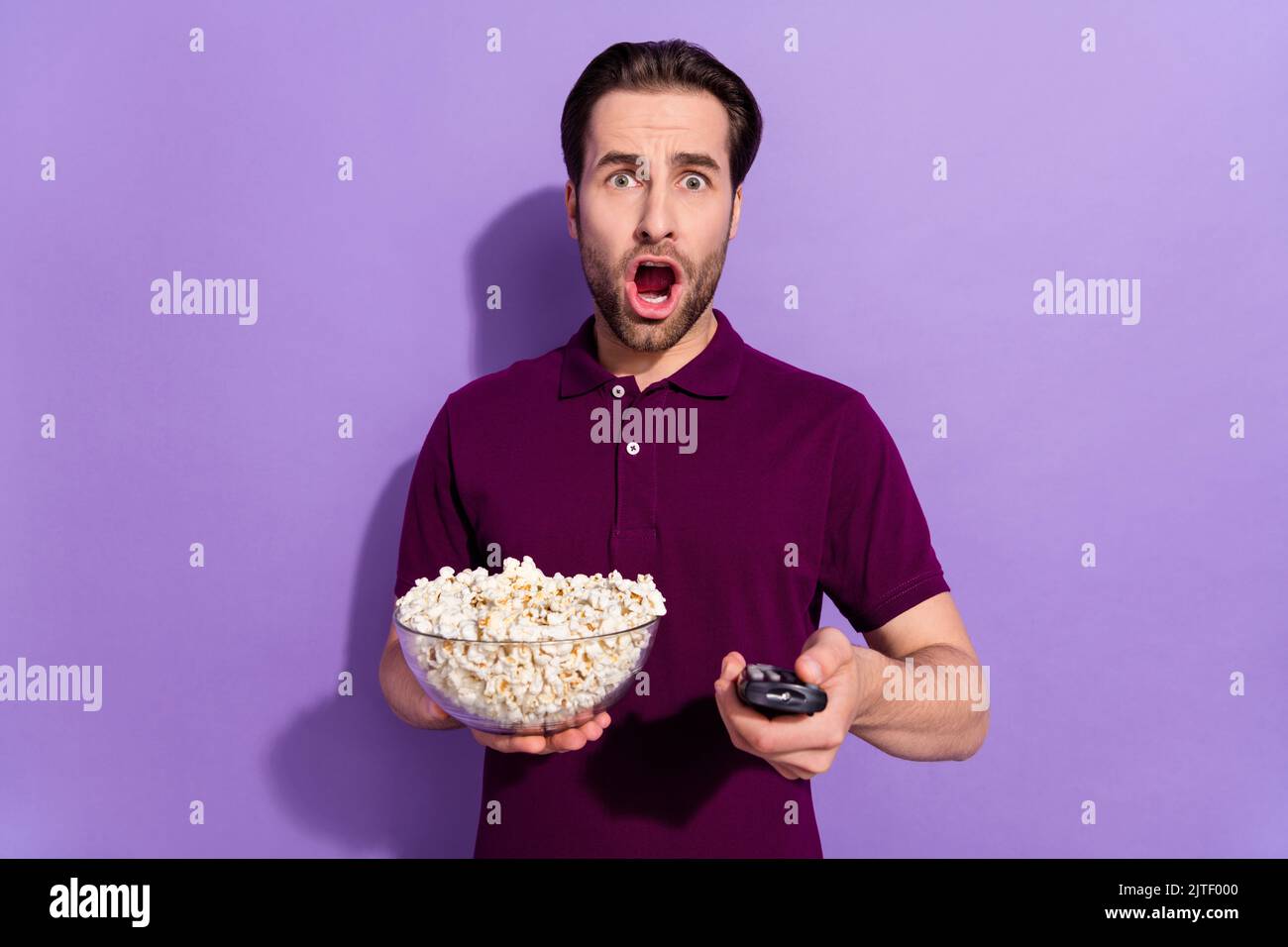 Photo of hooray young brunet guy yell eat pop corn watch tv wear violet ...