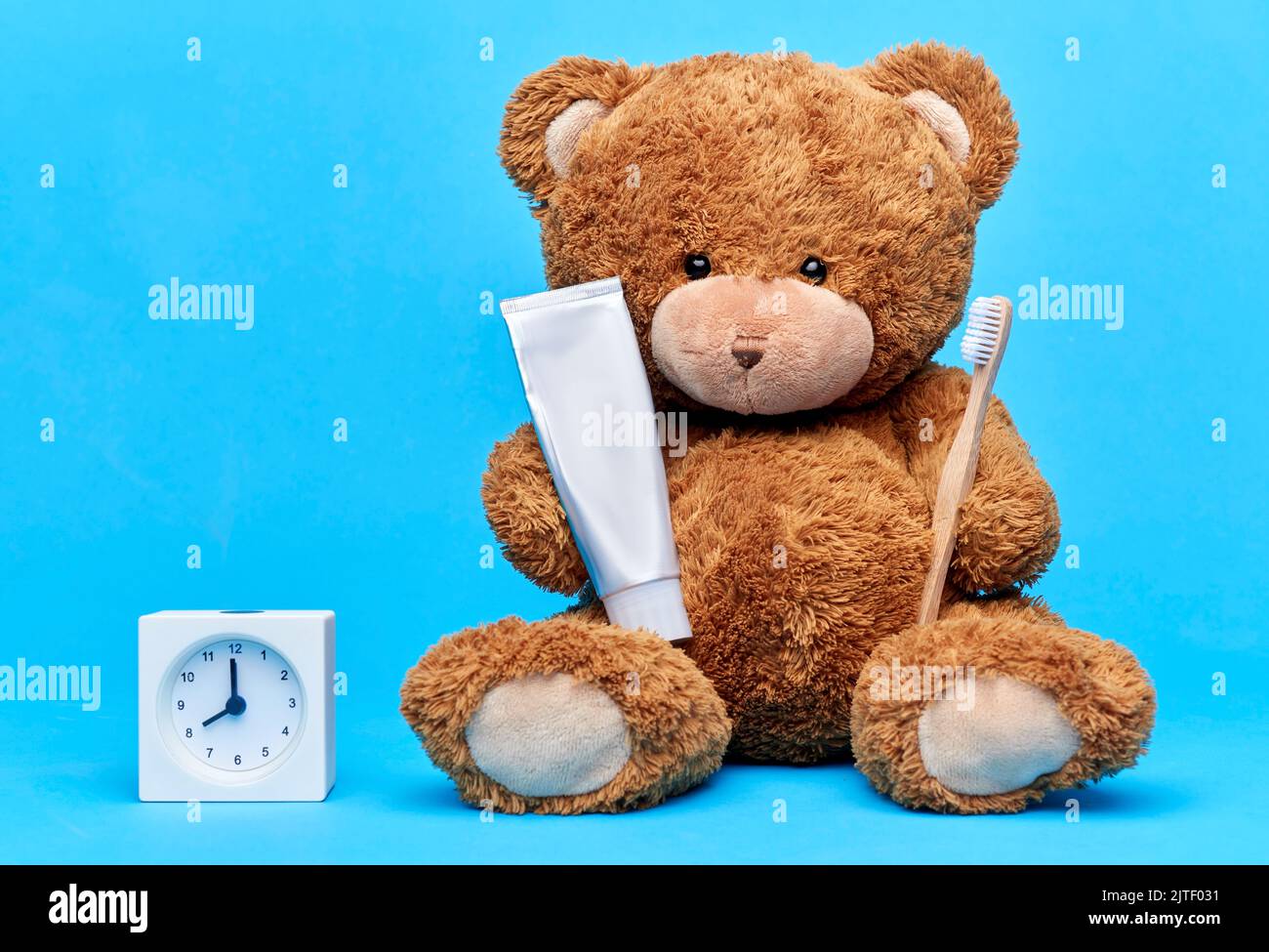 teddy bear with toothbrush, toothpaste and clock Stock Photo - Alamy