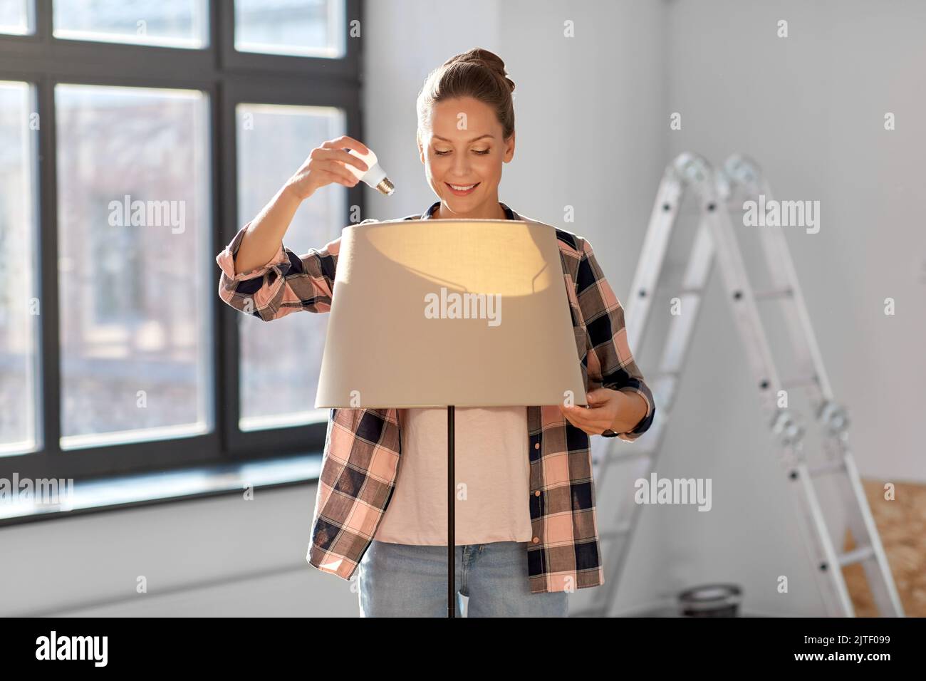 woman changing light bulb at new home Stock Photo - Alamy