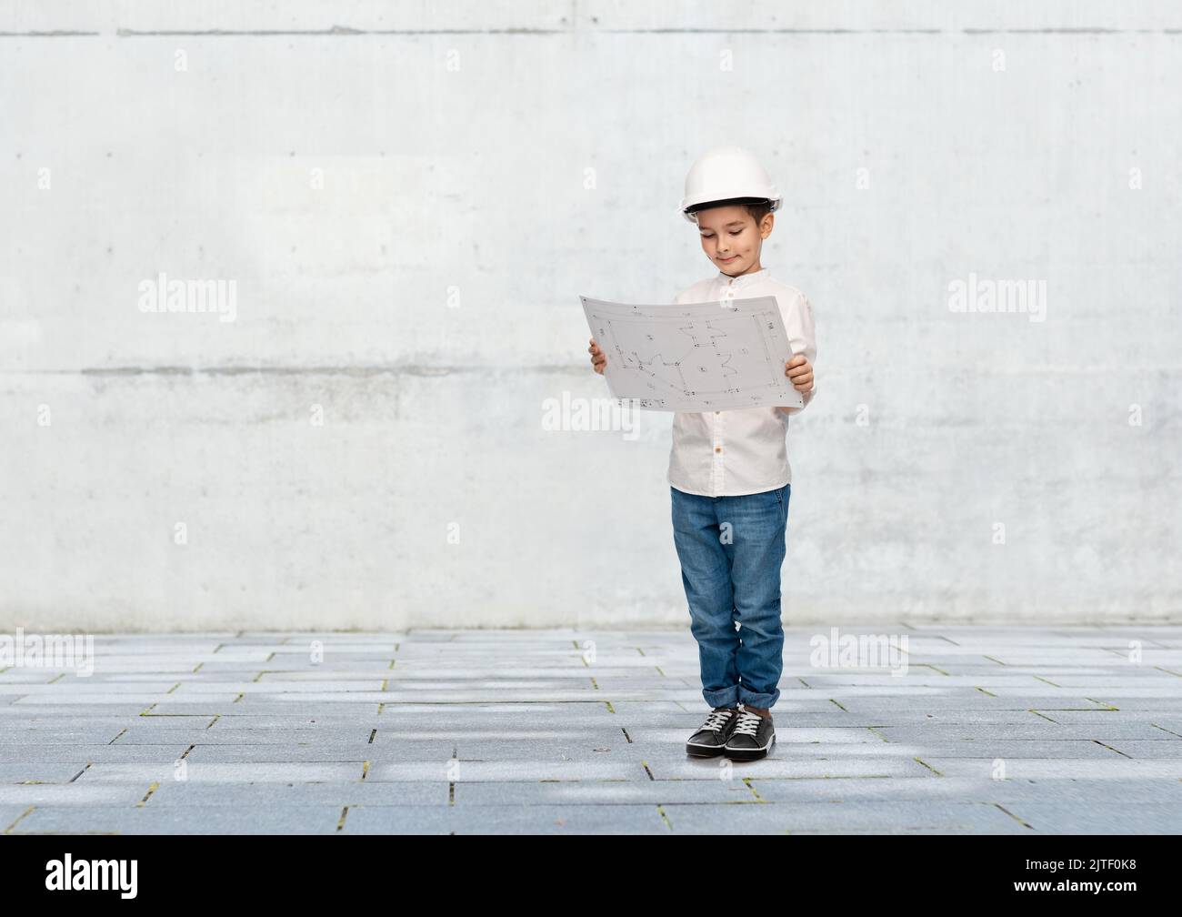little boy in construction helmet with blueprint Stock Photo - Alamy
