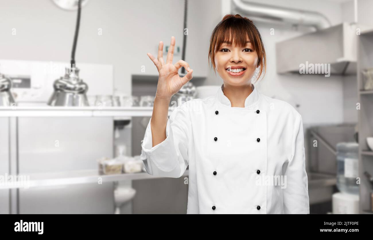 happy female chef showing ok hand sign on kitchen Stock Photo - Alamy