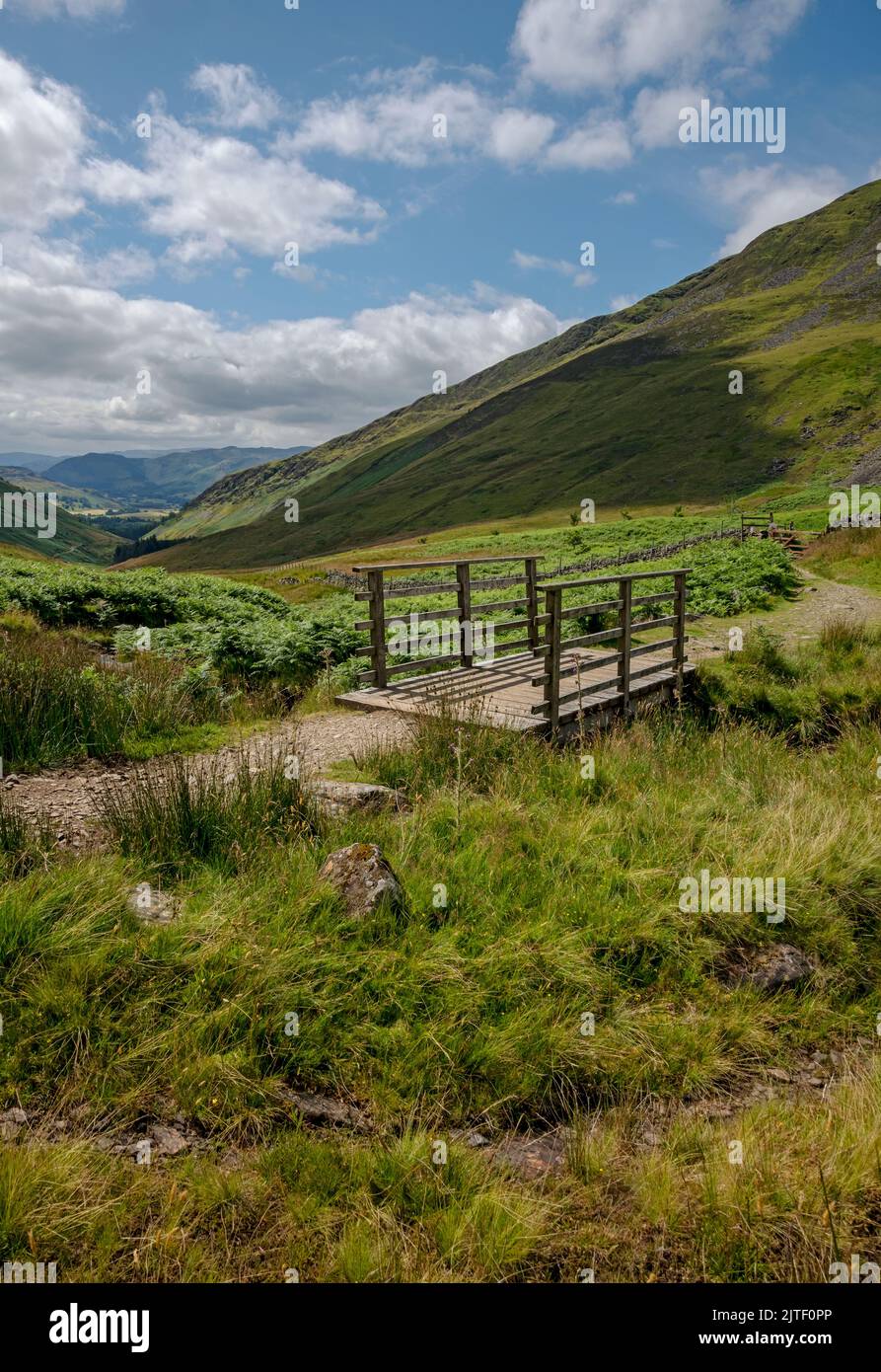 Footbridge path across Glenderaterra Beck at the head of valley between ...