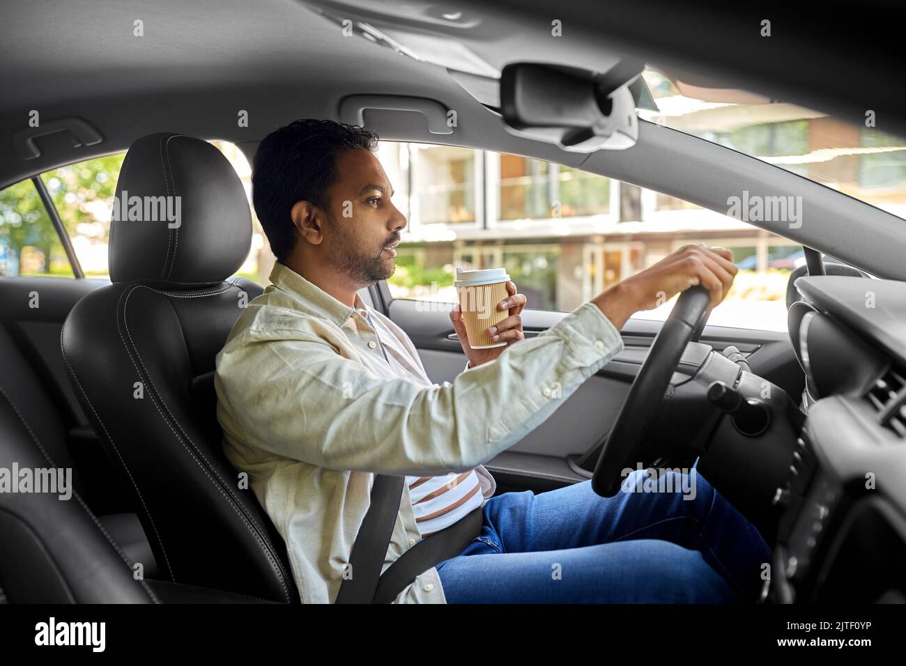 indian man or driver with coffee driving car Stock Photo - Alamy