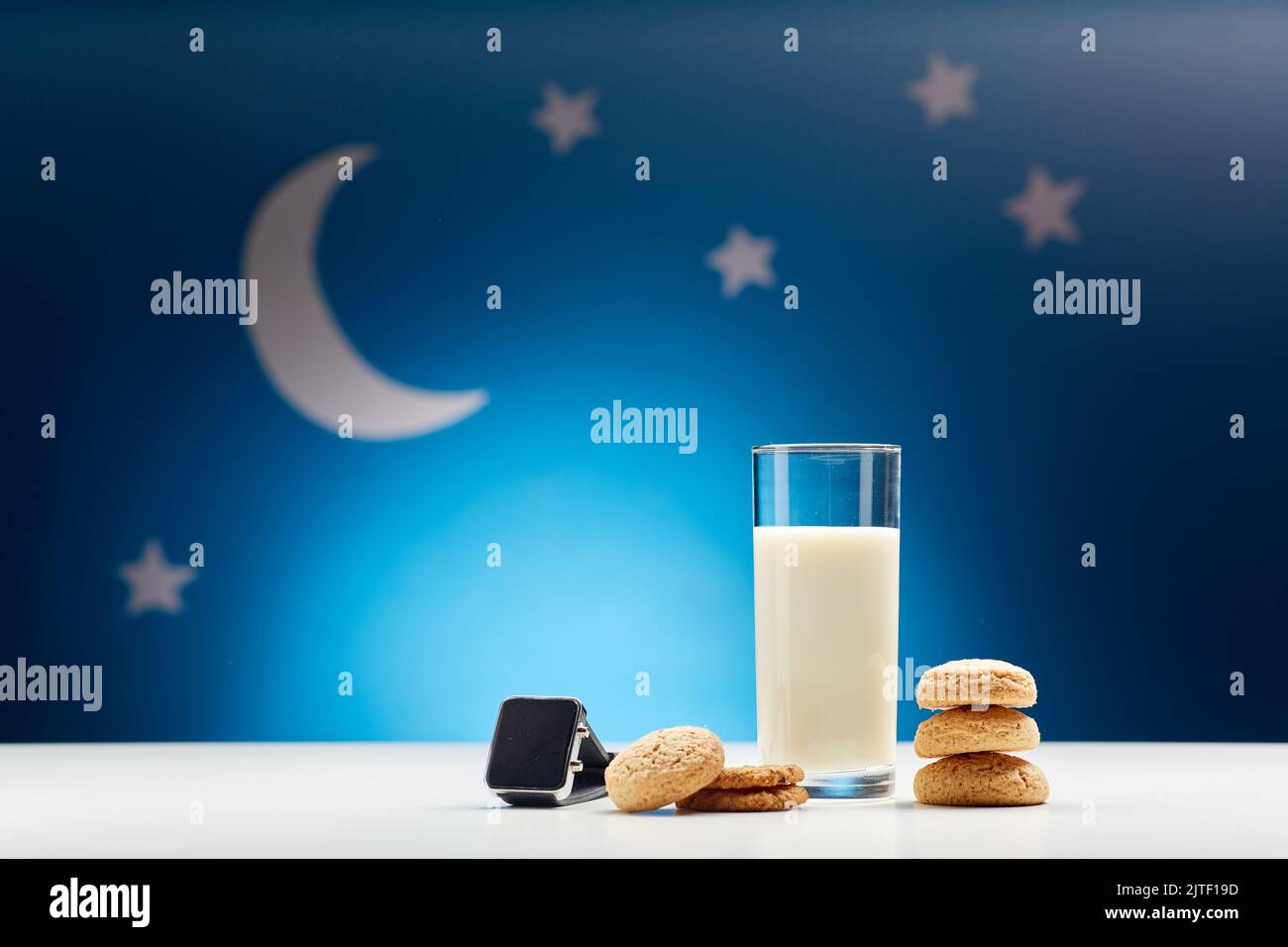 glass of milk, cookies and smart watch at night Stock Photo - Alamy