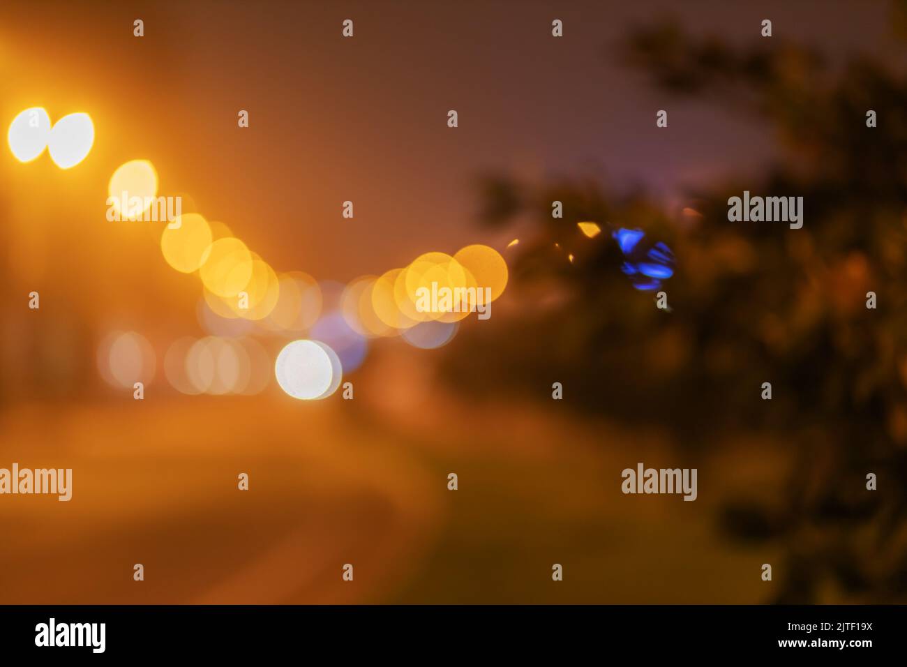 Blurred night cityscape in fog. Night glowing city. Out of focus Stock ...