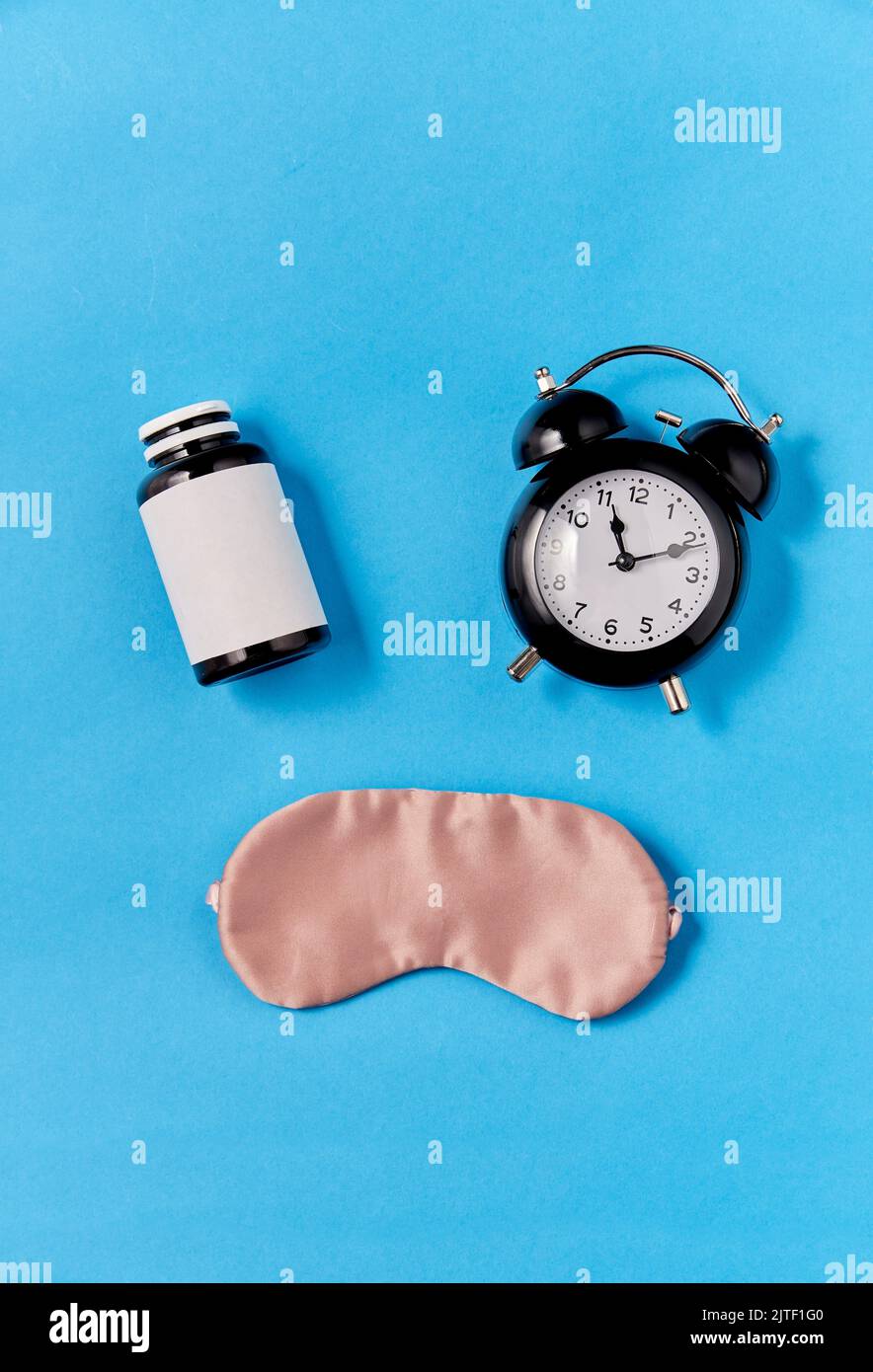 alarm clock, eye sleeping mask and pills Stock Photo - Alamy