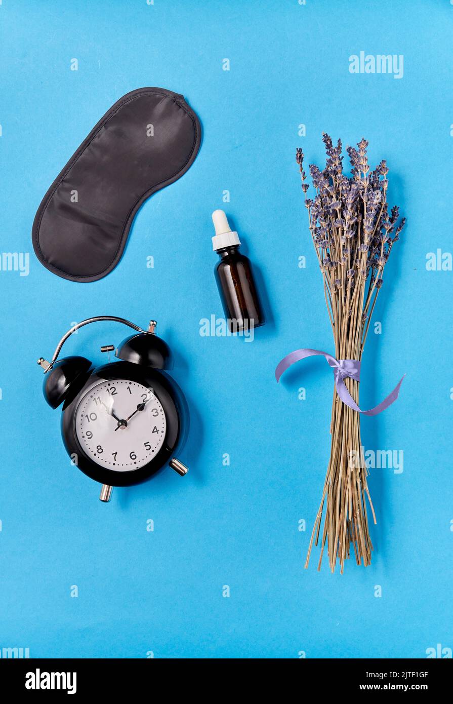 alarm clock, eye sleeping mask and lavender oil Stock Photo - Alamy