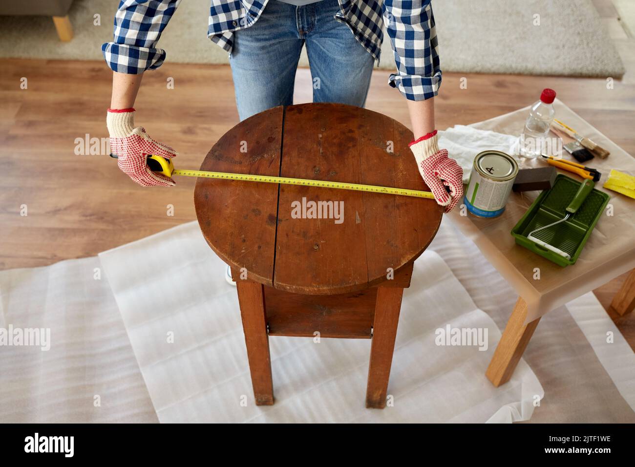 woman with ruler measuring table for renovation Stock Photo - Alamy