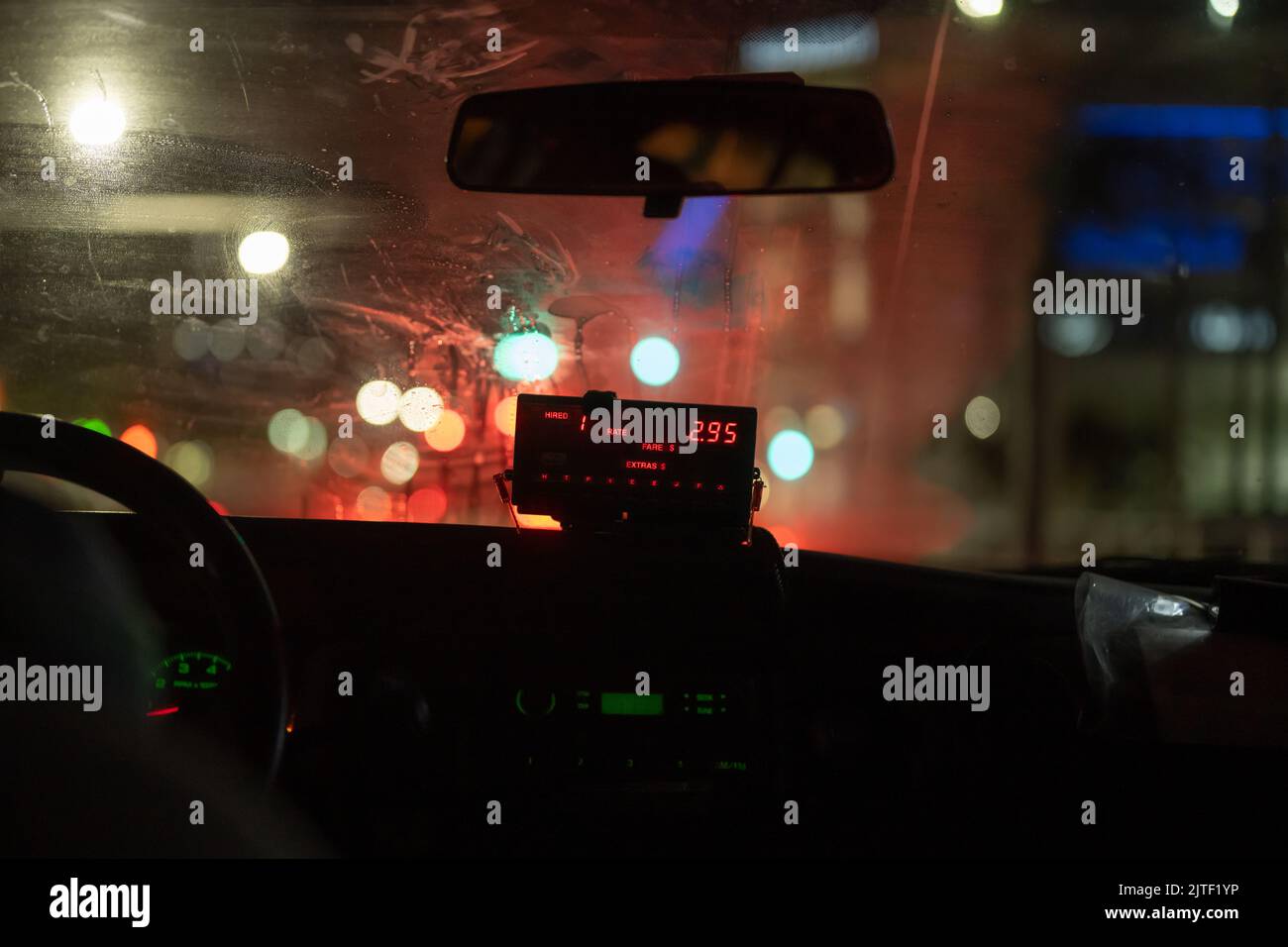 Miami taxi meter closeup with out of focus street lights at night ...