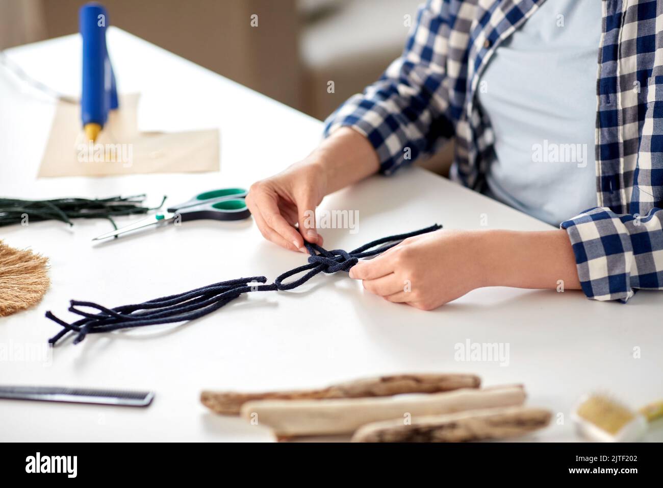 woman making macrame and knotting cords Stock Photo - Alamy
