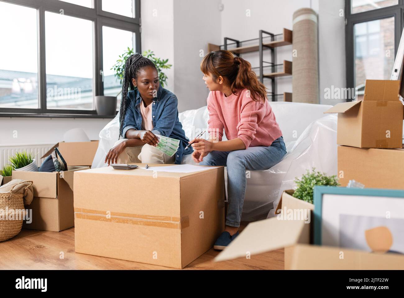 women moving to new home and counting money Stock Photo - Alamy
