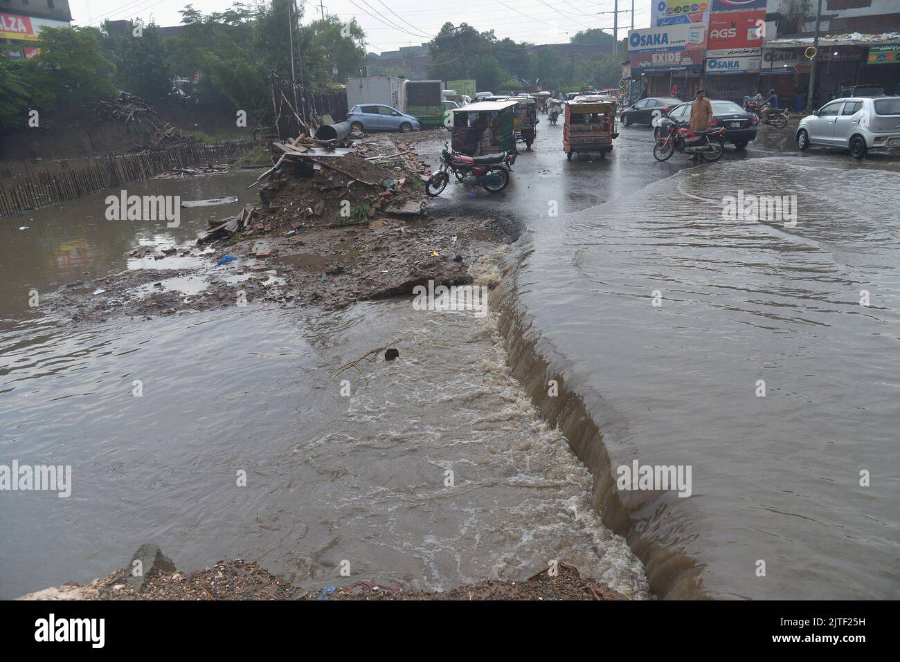 Pakistani people on their way and busy in Badami bagh vegetable market during heavy monsoon ...