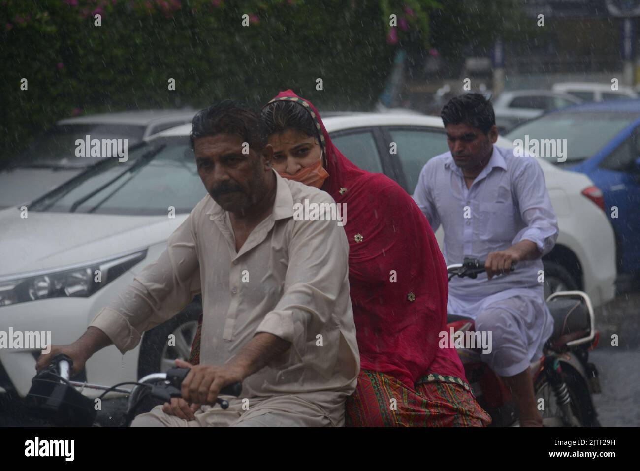 Pakistani people on their way and busy in Badami bagh vegetable market during heavy monsoon ...