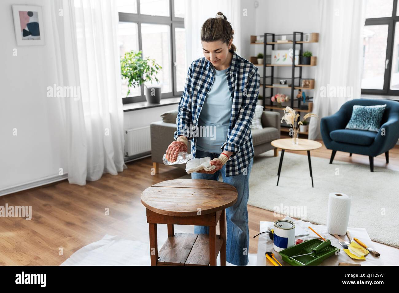 woman applying solvent to rag at home Stock Photo - Alamy
