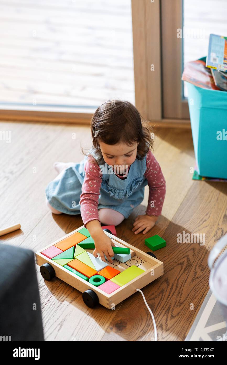 happy baby girl playing with toy blocks at home Stock Photo - Alamy