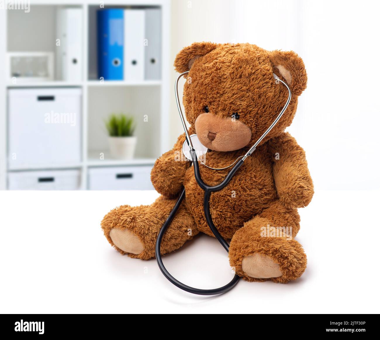 teddy bear with stethoscope at clinic Stock Photo - Alamy