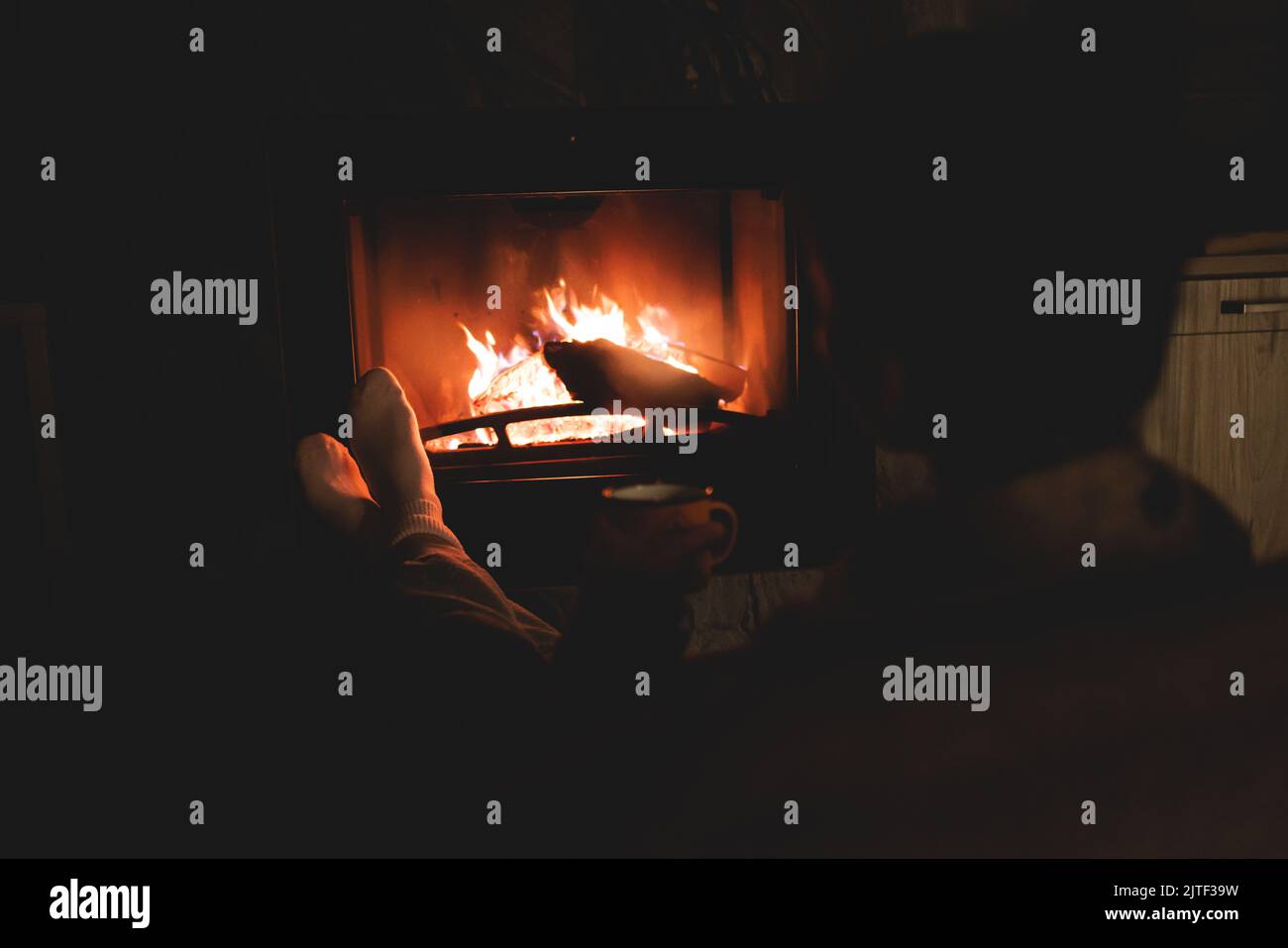 Cozy night in the cabin by the fireplace, fireplace burns in the ...