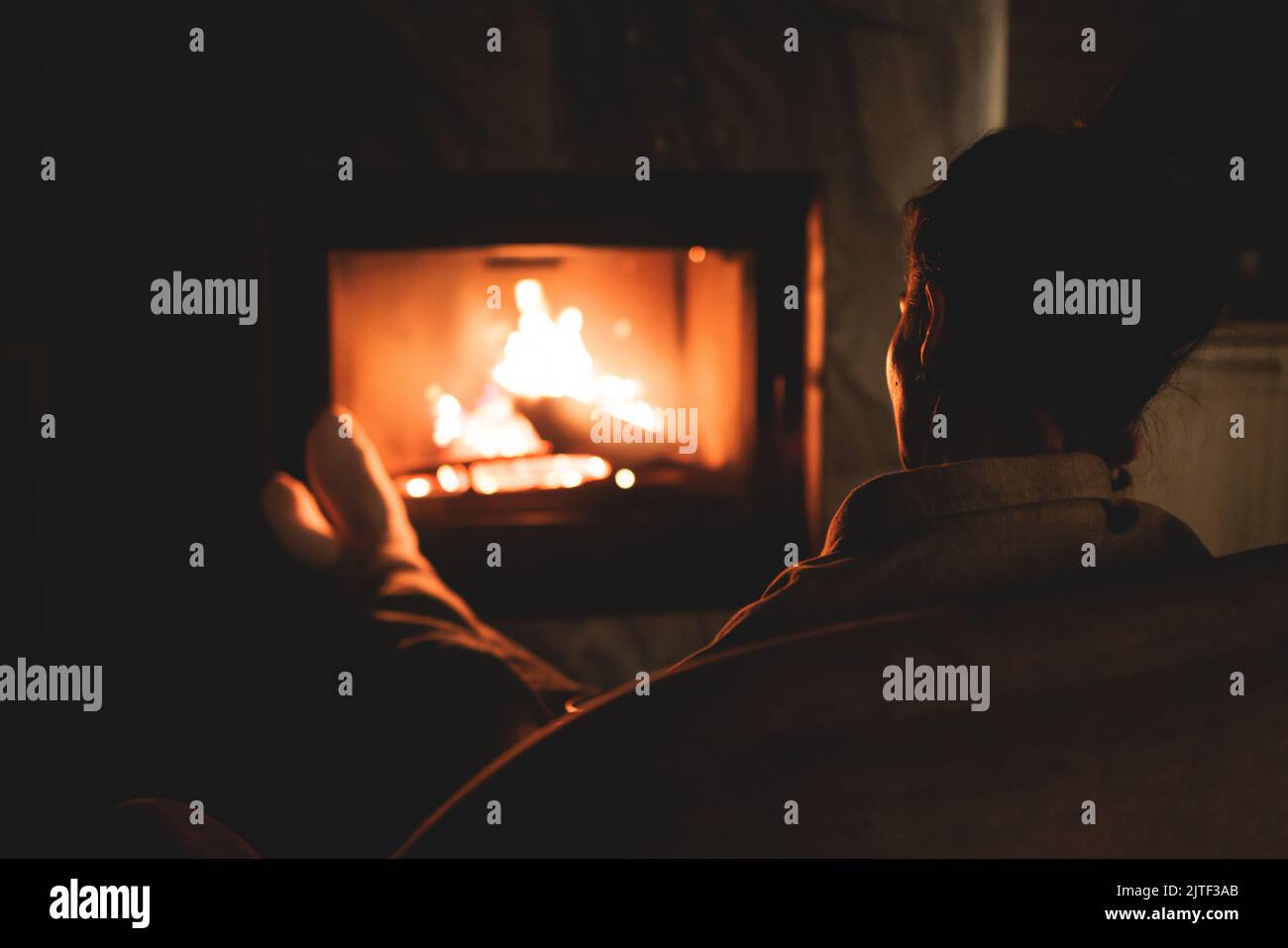 Cozy night in the cabin by the fireplace, fireplace burns in the ...