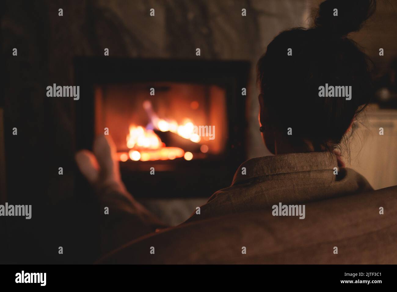 Cozy night in the cabin by the fireplace, fireplace burns in the ...