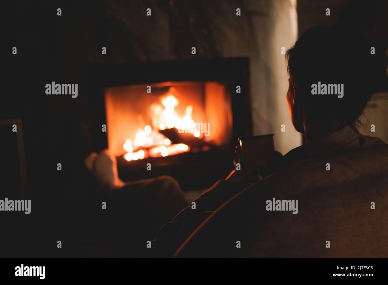 Cozy night in the cabin by the fireplace, fireplace burns in the ...