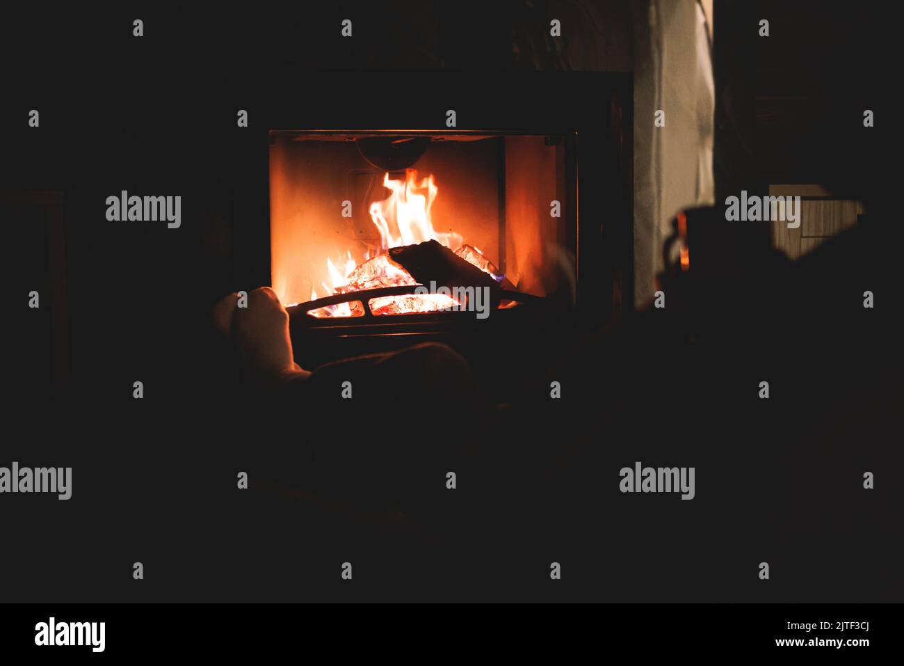 Cozy night in the cabin by the fireplace, fireplace burns in the ...