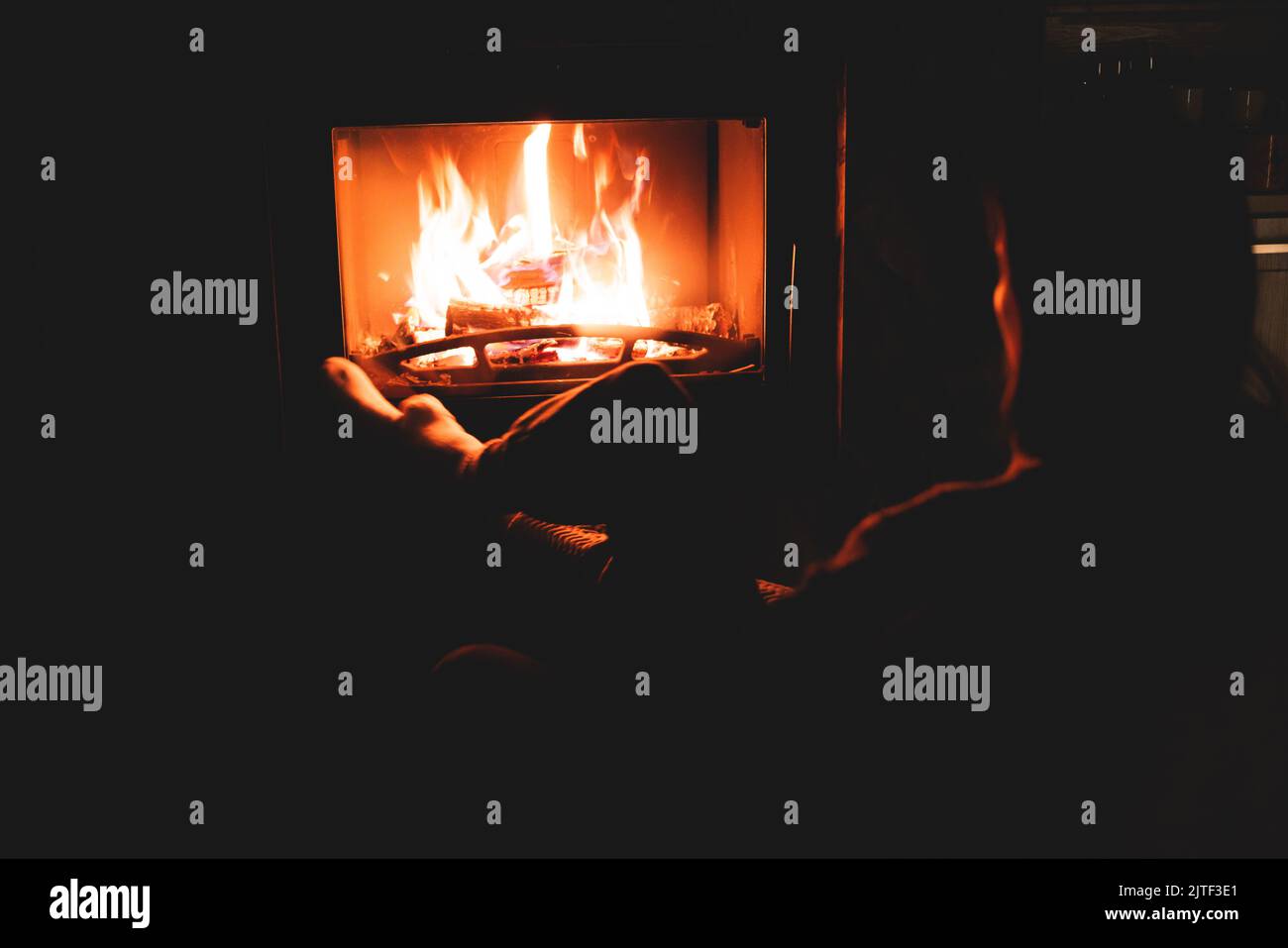 Cozy night in the cabin by the fireplace, fireplace burns in the ...