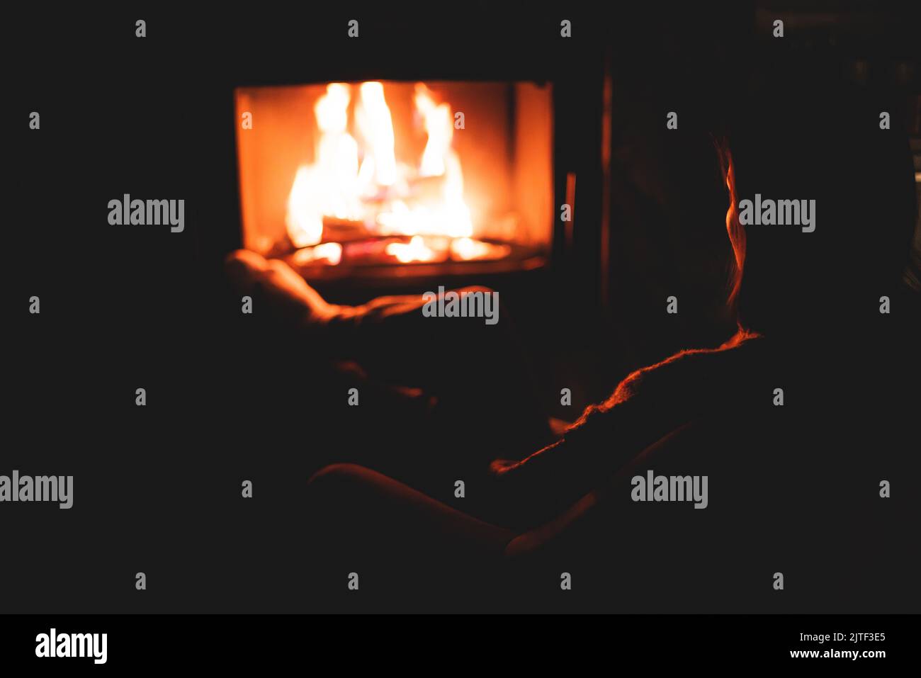 Cozy night in the cabin by the fireplace, fireplace burns in the ...