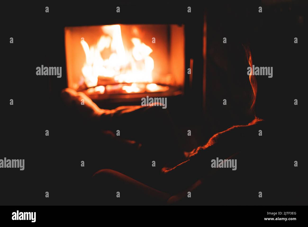 Cozy night in the cabin by the fireplace, fireplace burns in the ...