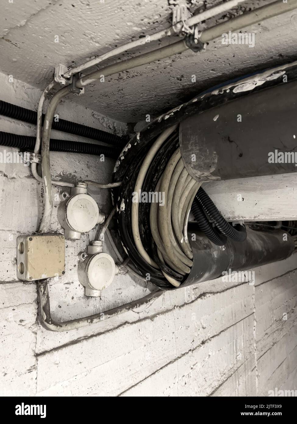 Electricity cables and installation in house basement with concrete ...