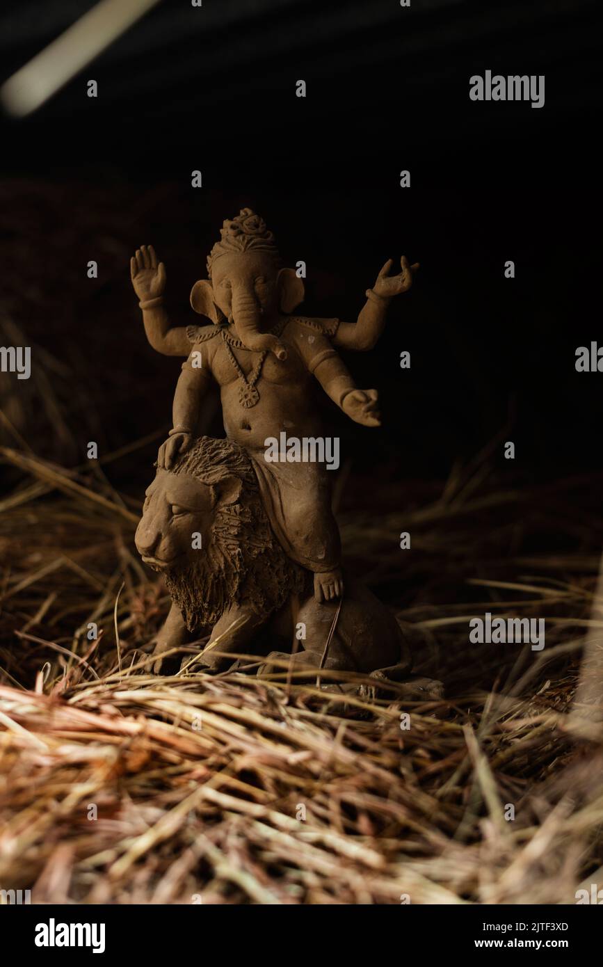 Closeup of unfinished clay model of Lord Ganesha sitting on a lion ...