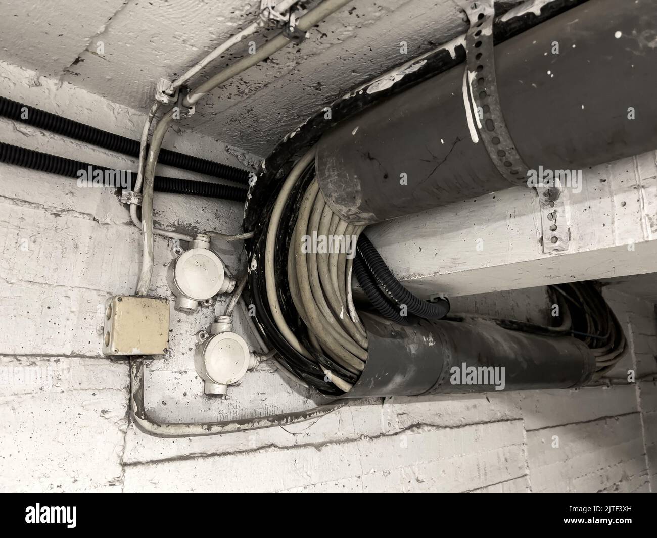 Electricity cables and installation in house basement with concrete ...