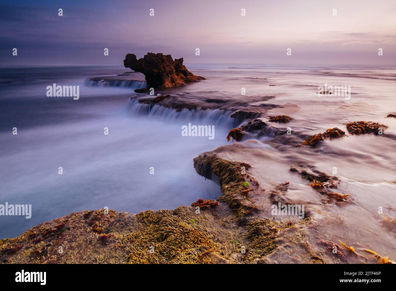 The iconic Dragon Head Rock at sunset on the Number Sixteen Beach in ...