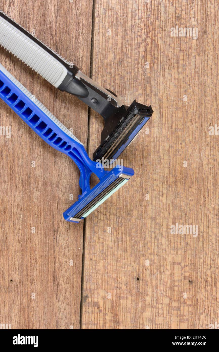 A top view of two sharp manual razors for men on a wooden surface Stock ...